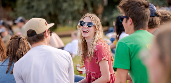 A group of UW students laugh together at a UW event on campus