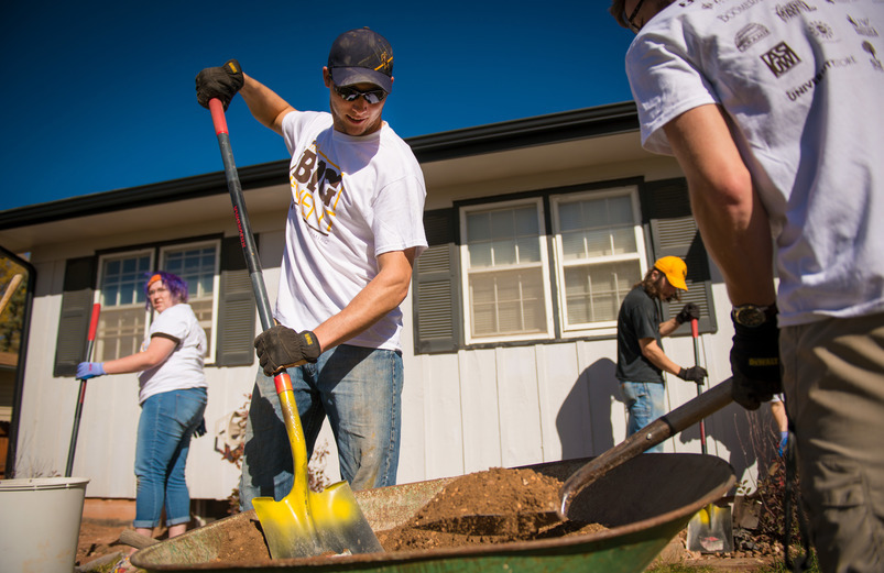 Members from UW fraternities and sororities participate in yard work as part of a community service project